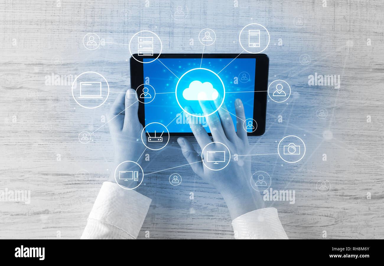 Hand touching tablet with cloud computing and online storage concept ...