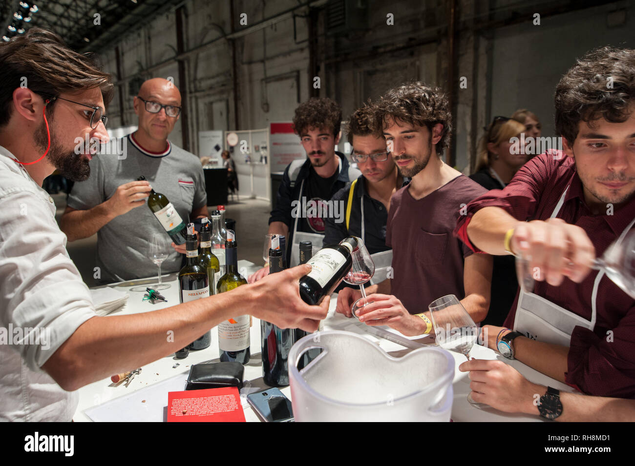 Young men during a wine tasting event Stock Photo - Alamy