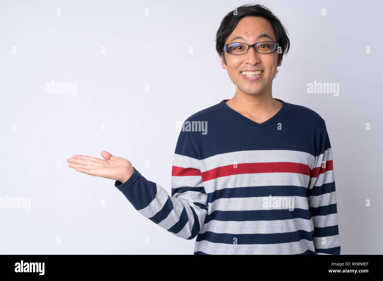 Portrait of happy Japanese man showing something Stock Photo - Alamy