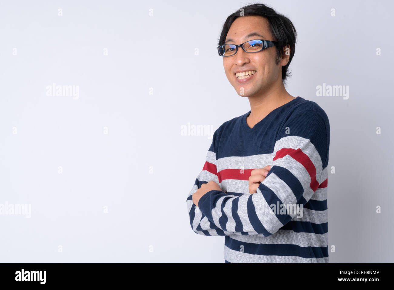 Profile view of happy Japanese man smiling with arms crossed Stock ...