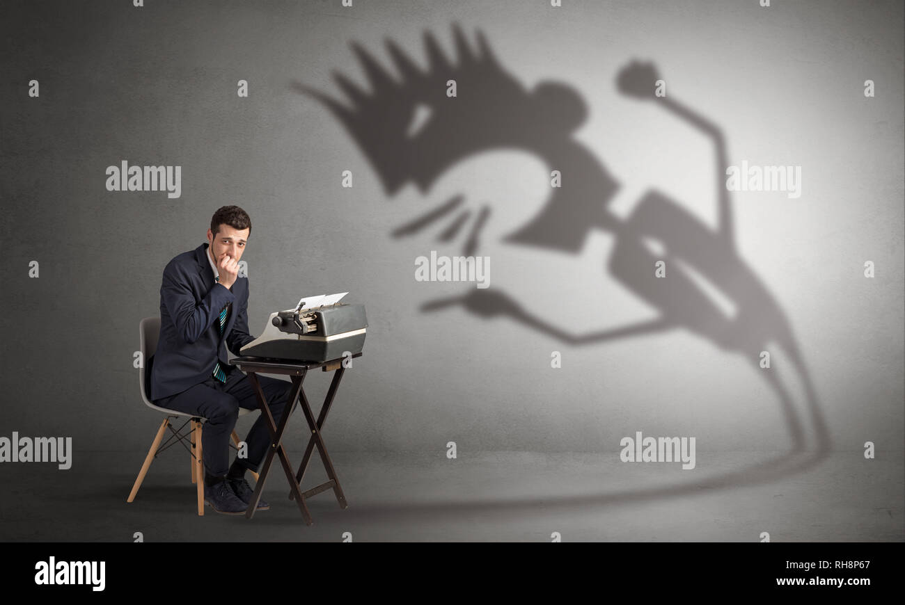 Man working hard and he is afraid of a yelling shadow Stock Photo - Alamy