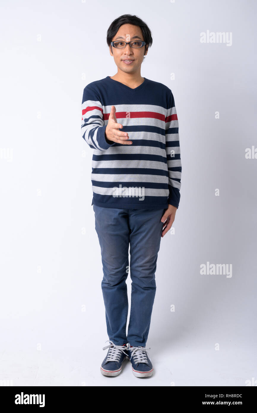 Full body shot of happy Japanese man giving handshake Stock Photo - Alamy