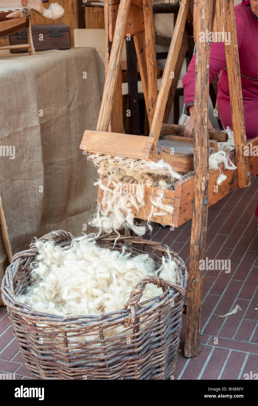 Carding raw wool with an old vintage wooden machine Stock Photo - Alamy