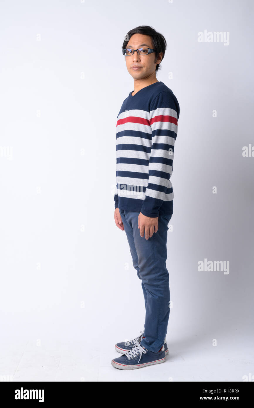 Full body shot profile view of Japanese man looking at camera Stock ...