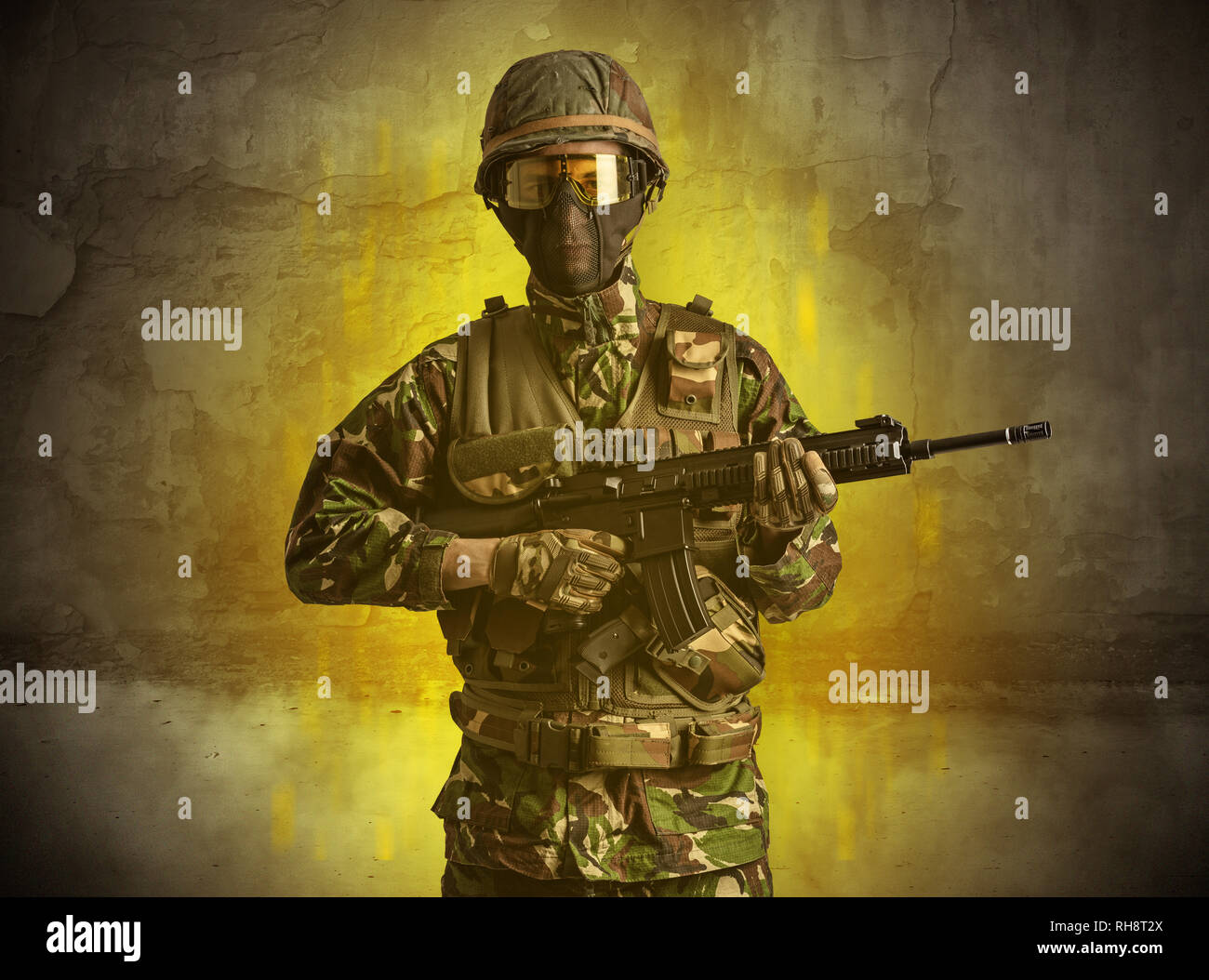 Hazard, menace soldier in a ruined crumbly building with arms on his ...