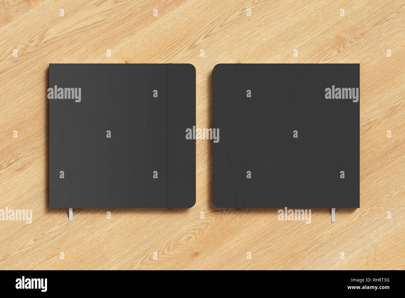 Black square notebook with elastic band on wooden background. Front and ...