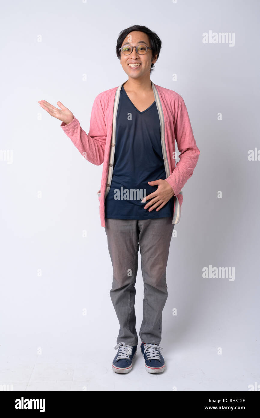 Full body shot of happy Japanese man showing something Stock Photo - Alamy