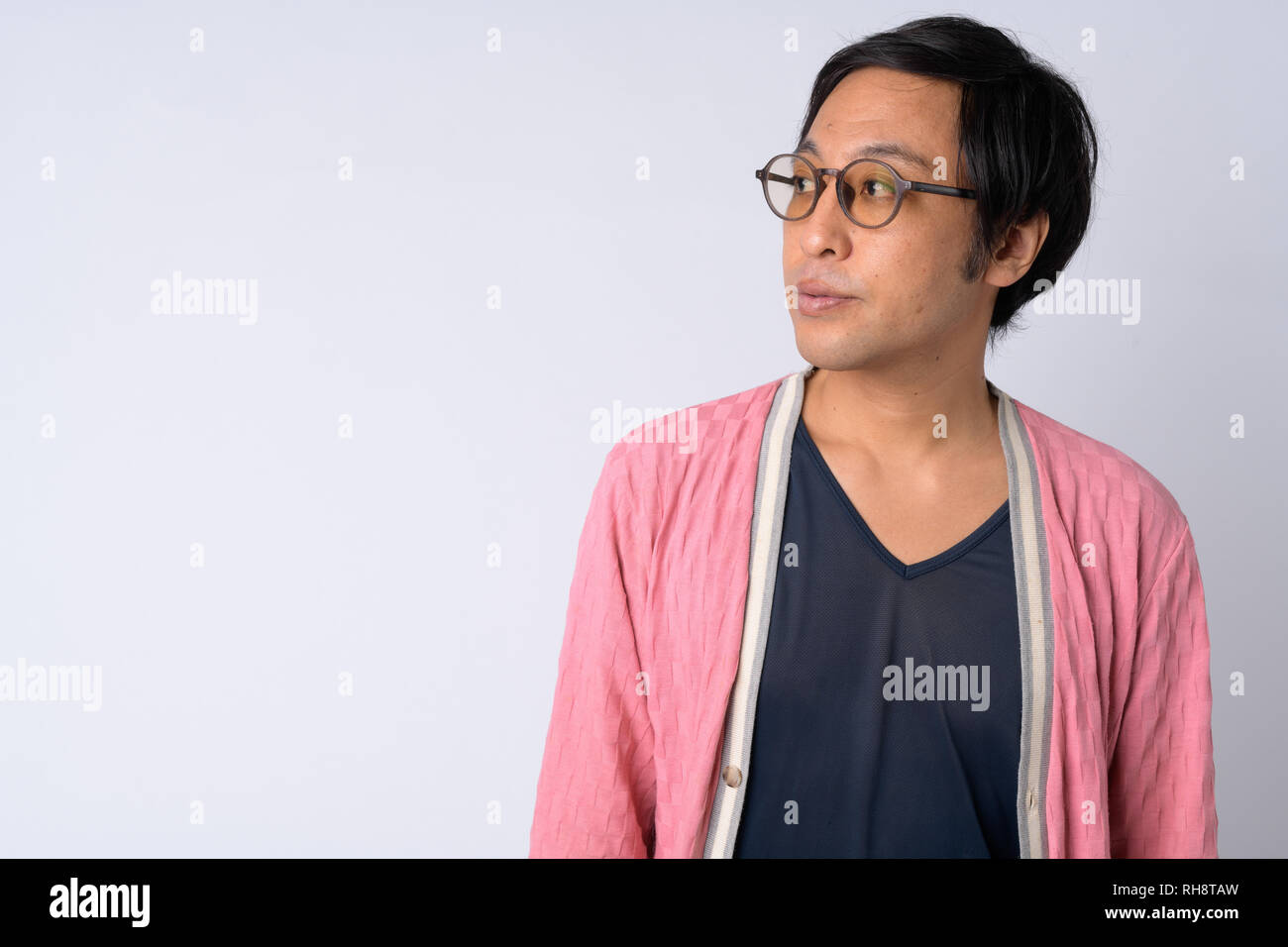 Portrait of Japanese man thinking against white background Stock Photo ...
