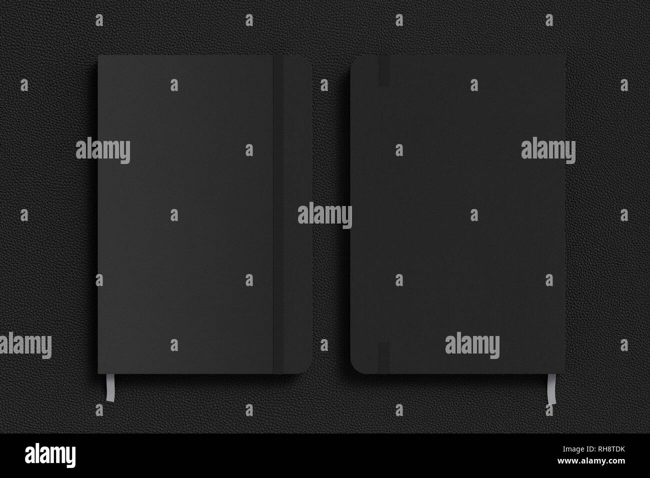 Black vertical notebook with elastic band on black background. Front ...