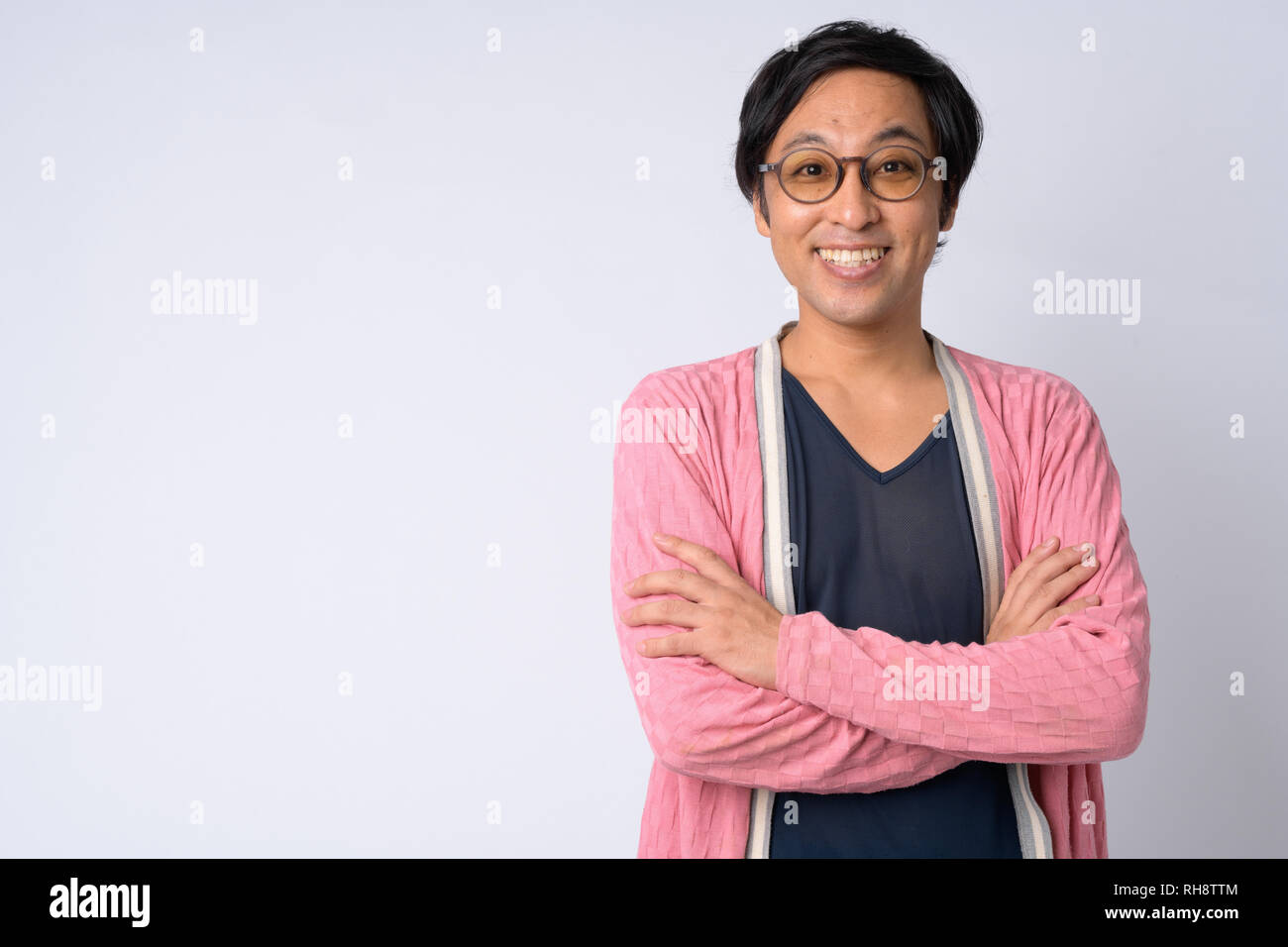Portrait of happy Japanese man smiling with arms crossed Stock Photo ...