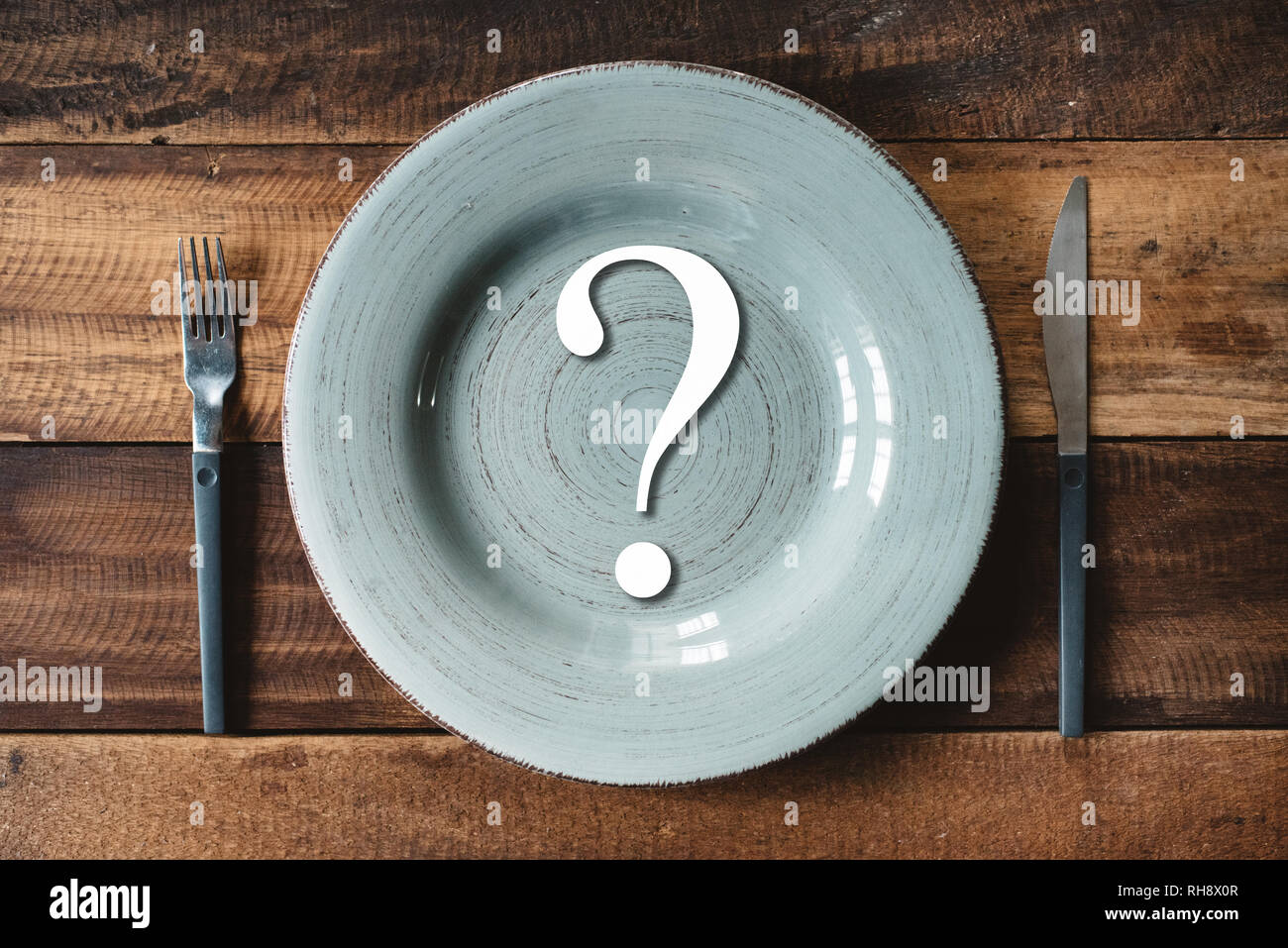 top view of a table set of cutlery with symbol of question mark in a ...