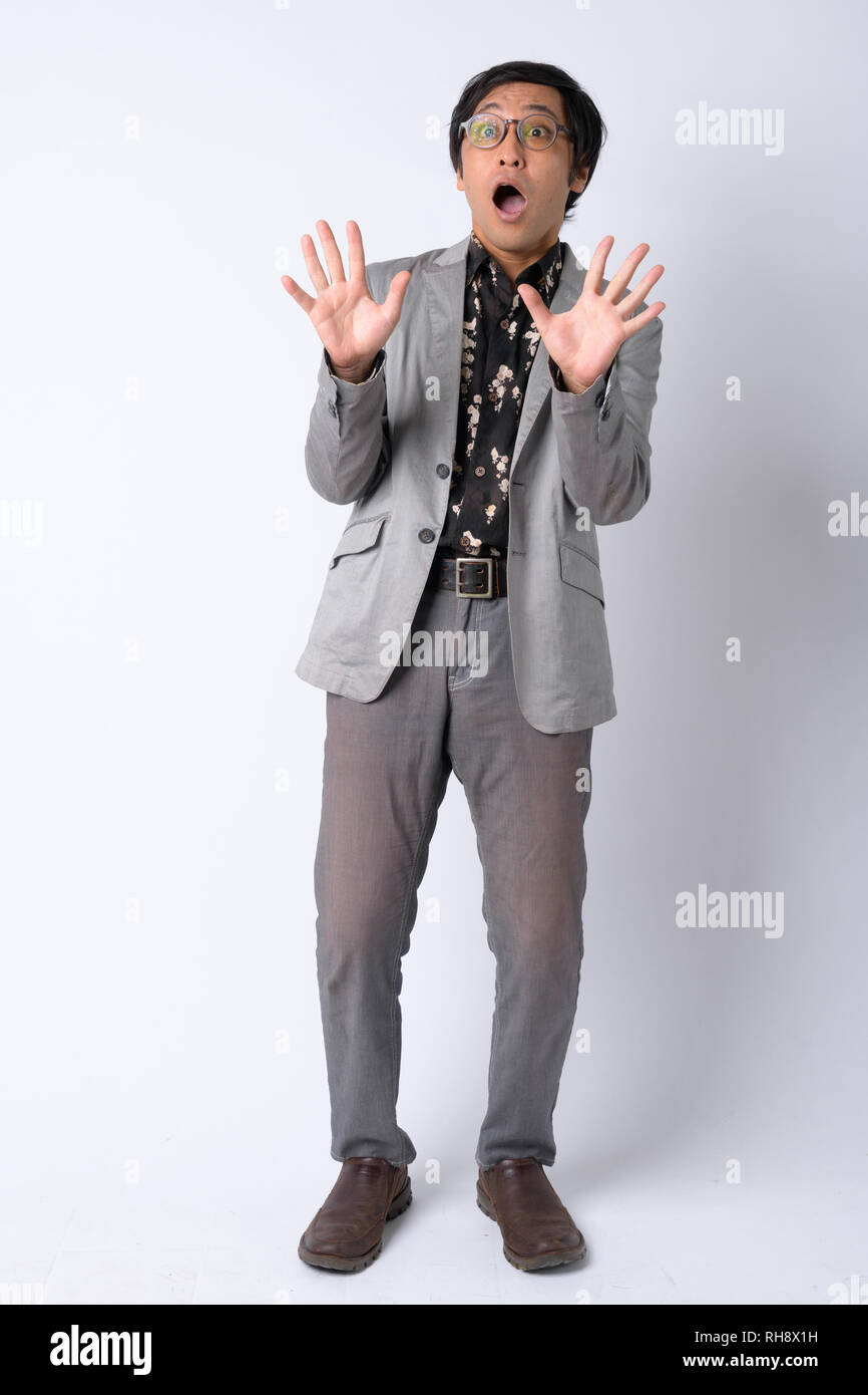 Full body shot of Japanese businessman looking shocked and scared Stock ...