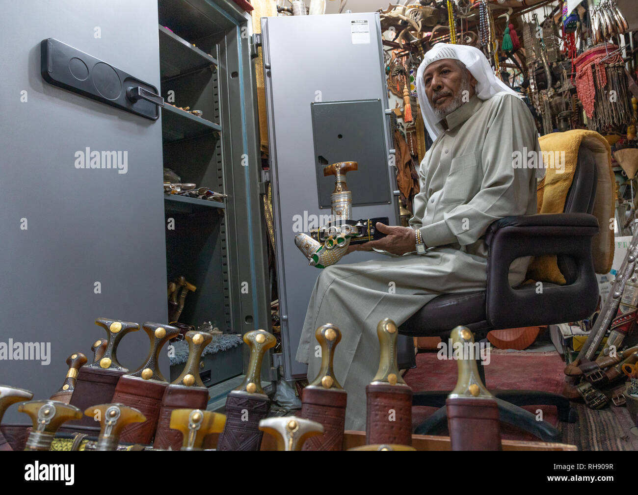 Saudi man holding a janbiya dagger kept in a safe, Najran Province ...