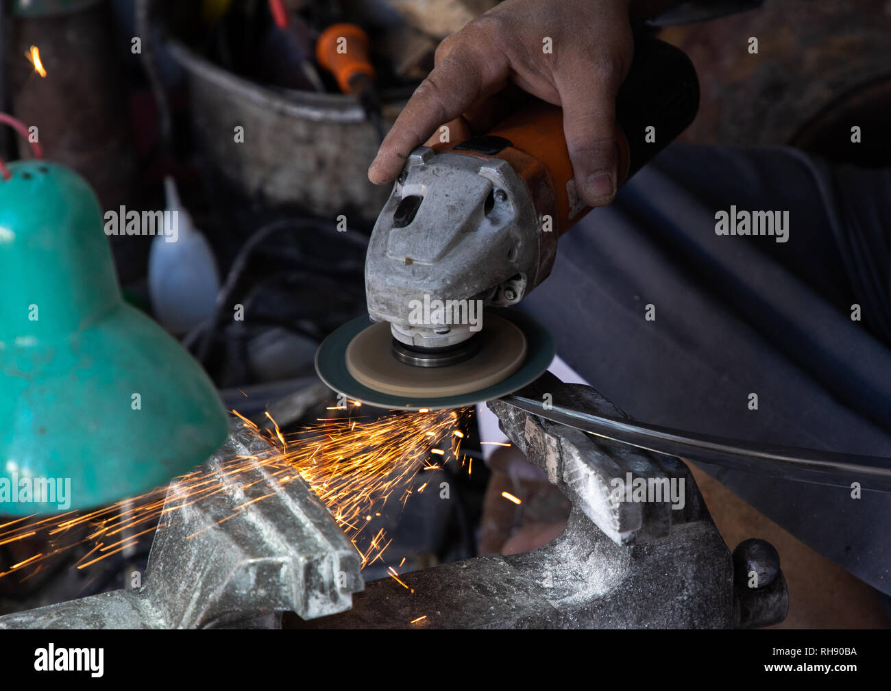 A saudi man prepares a traditional janbiya dagger for sale inside his ...