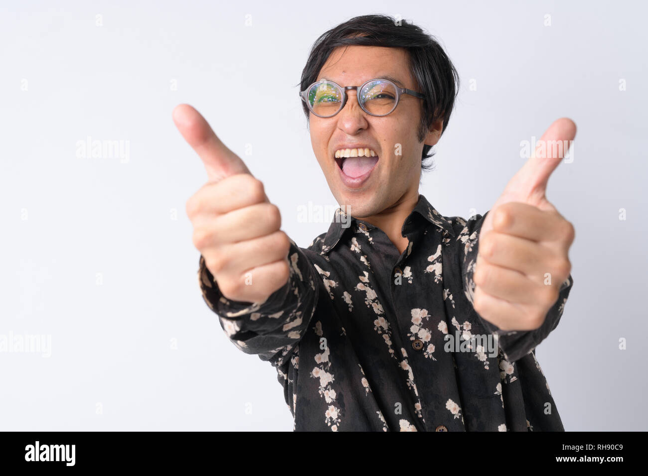 Portrait of happy Japanese businessman giving thumbs up Stock Photo - Alamy