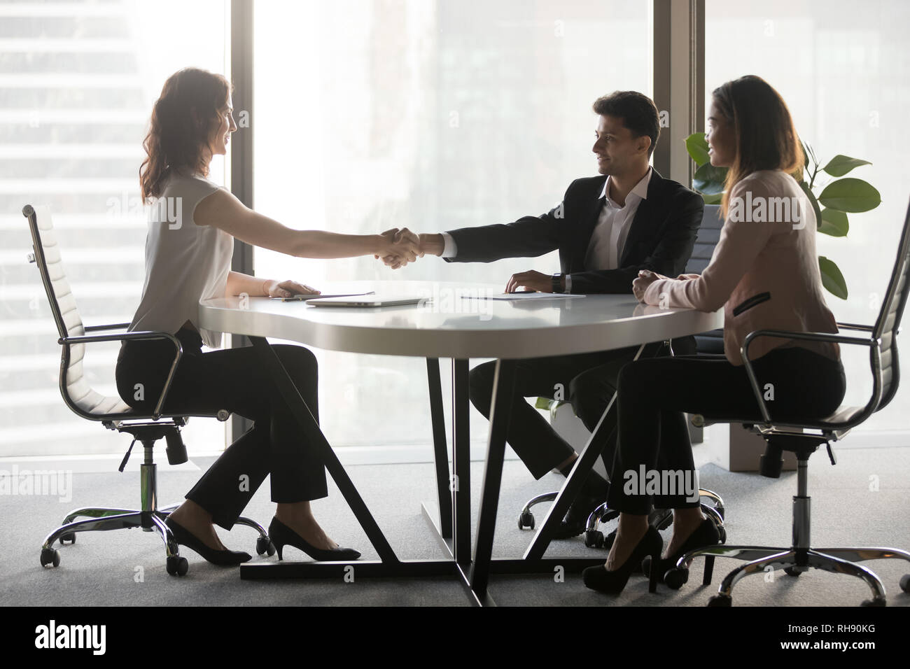 Happy diverse business partners handshaking at office meeting Stock ...