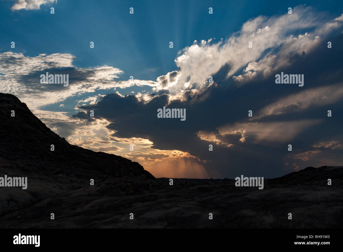 Crepuscular rays and glowing cloud edges during sunset, view from ...