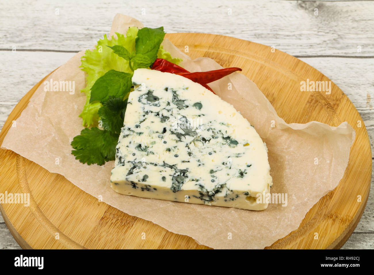 Blue cheese slice with salad leaves Stock Photo - Alamy