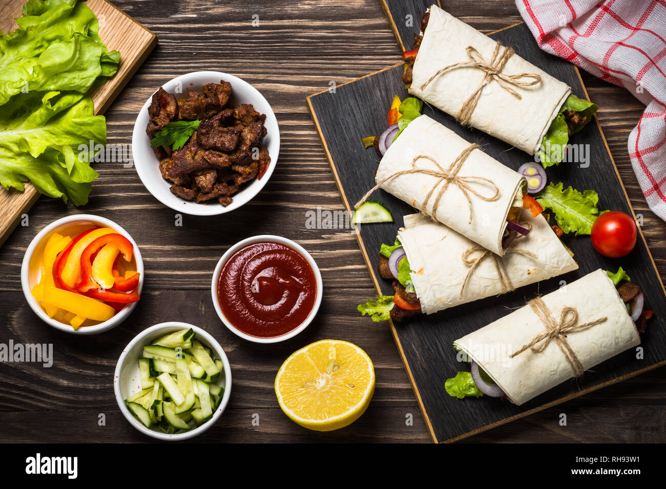 Burritos tortilla wraps with beef and vegetables with ingredients in ...