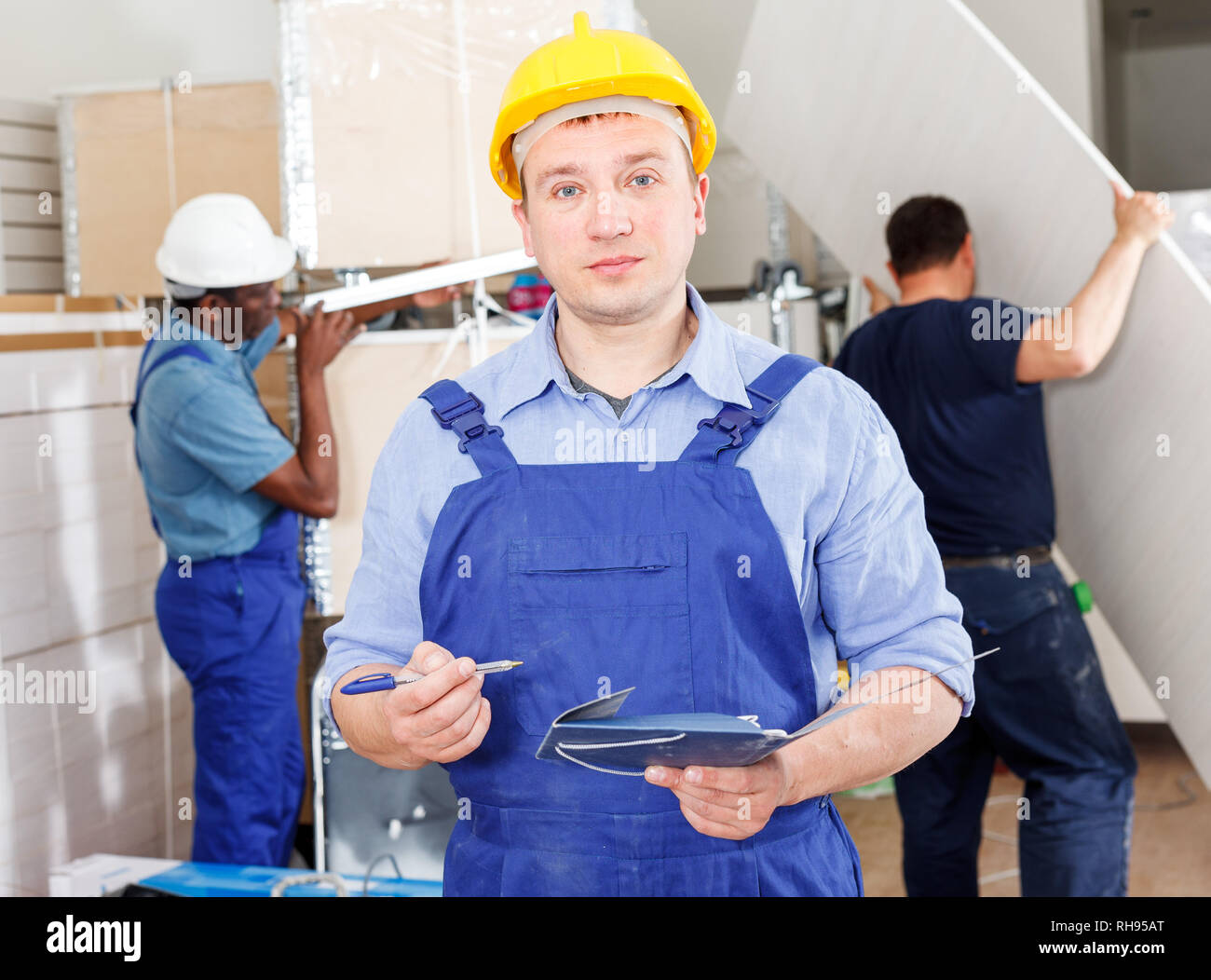 Professional male contractor looking at room and determining scope of ...