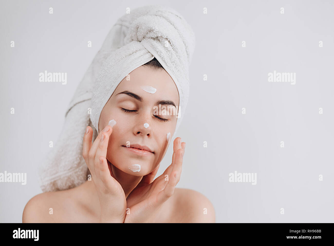 Skin care. Young and beautiful girl using a skin care product ...