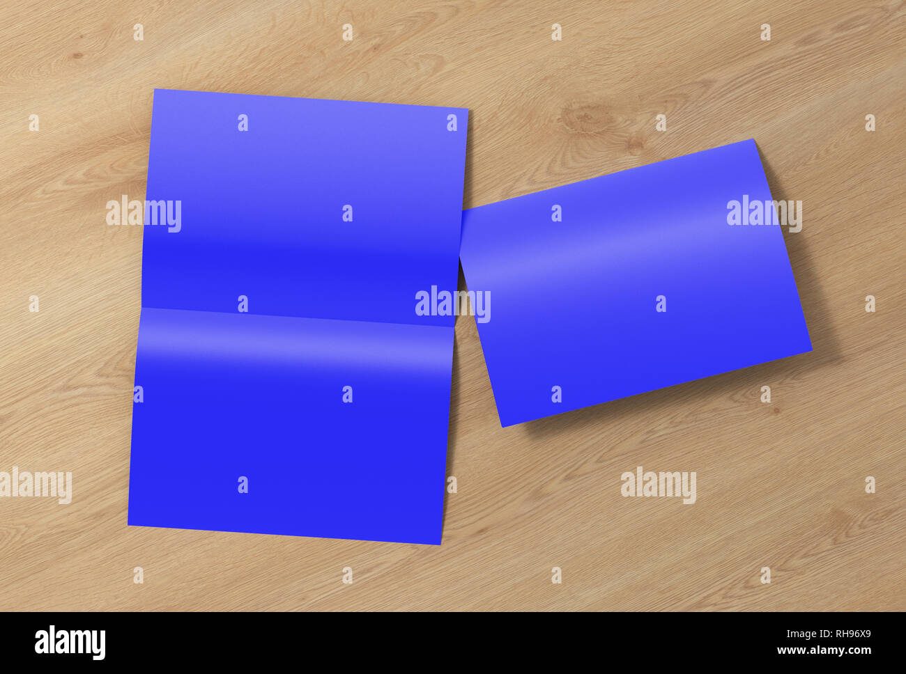 Blank blue open and folded half-folded flyer leaflet on wooden ...