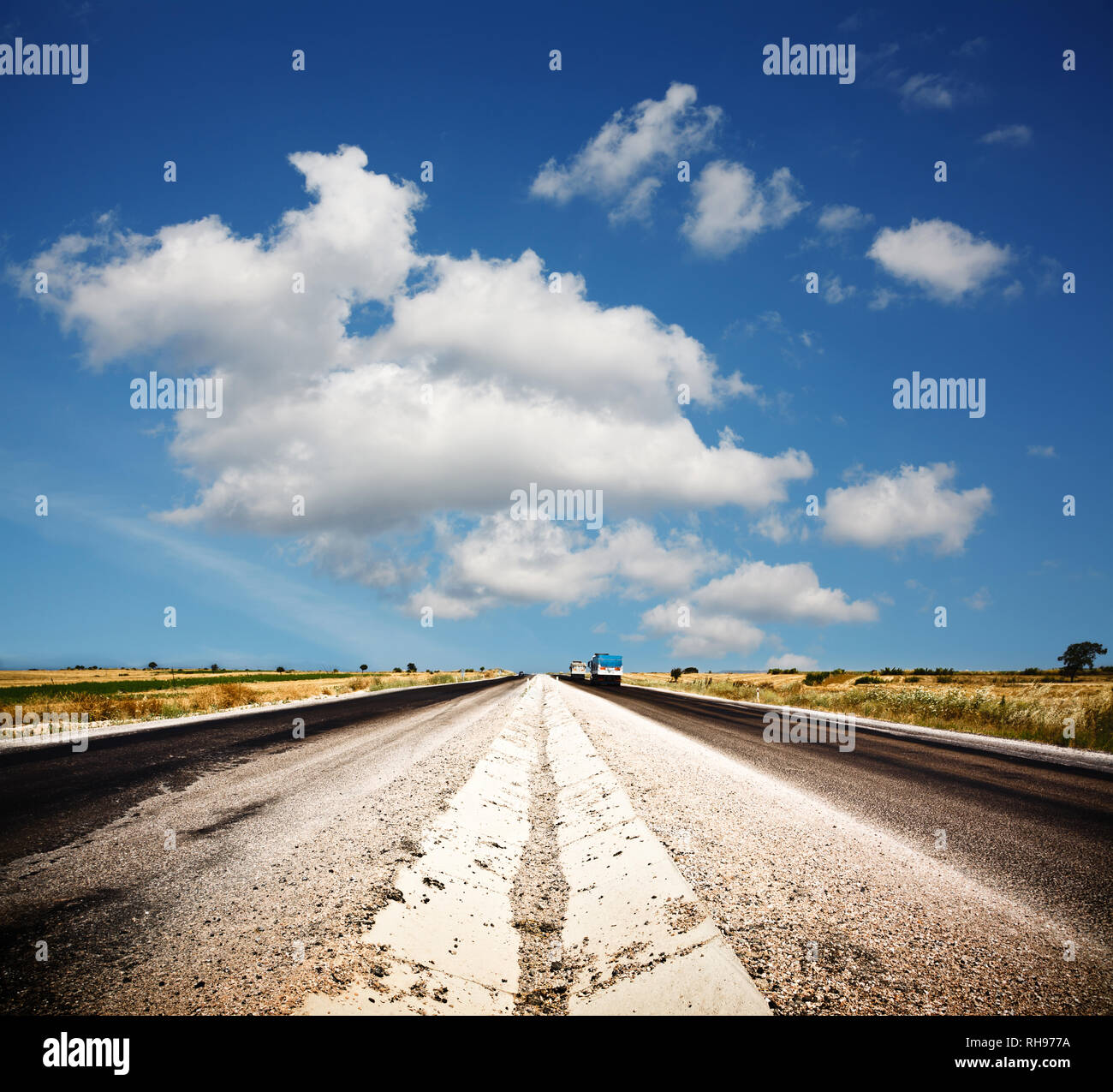 Asphalt road through the green field Stock Photo - Alamy