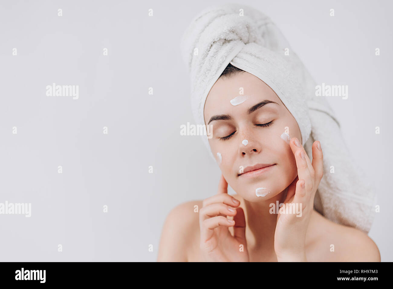 Skin care. Young and beautiful girl using a skin care product ...