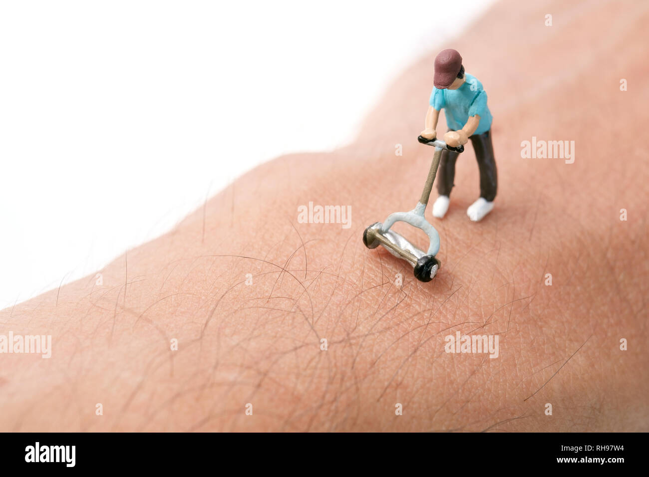 View of miniature toy worker on arm. Health concept Stock Photo - Alamy