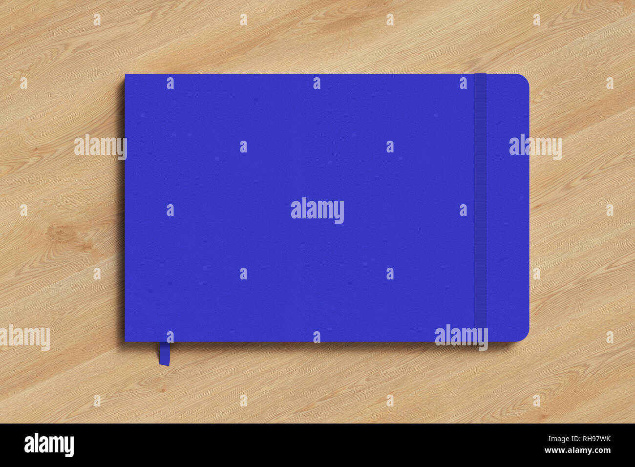 Blue horizontal notebook with elastic band on wooden background Stock ...