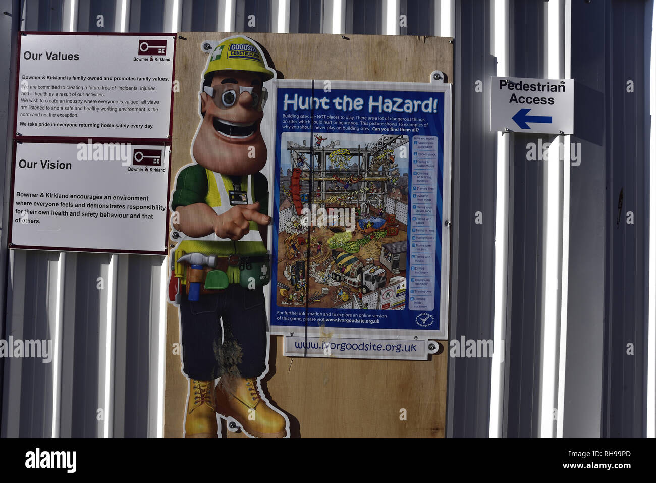 A "Hunt the Hazard" poster a construction site wall in central ...