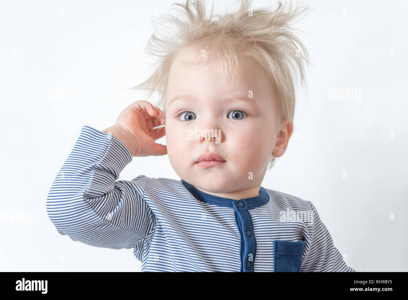 cute sleepy disheveled baby holding virtual mobile phone gesture Stock ...