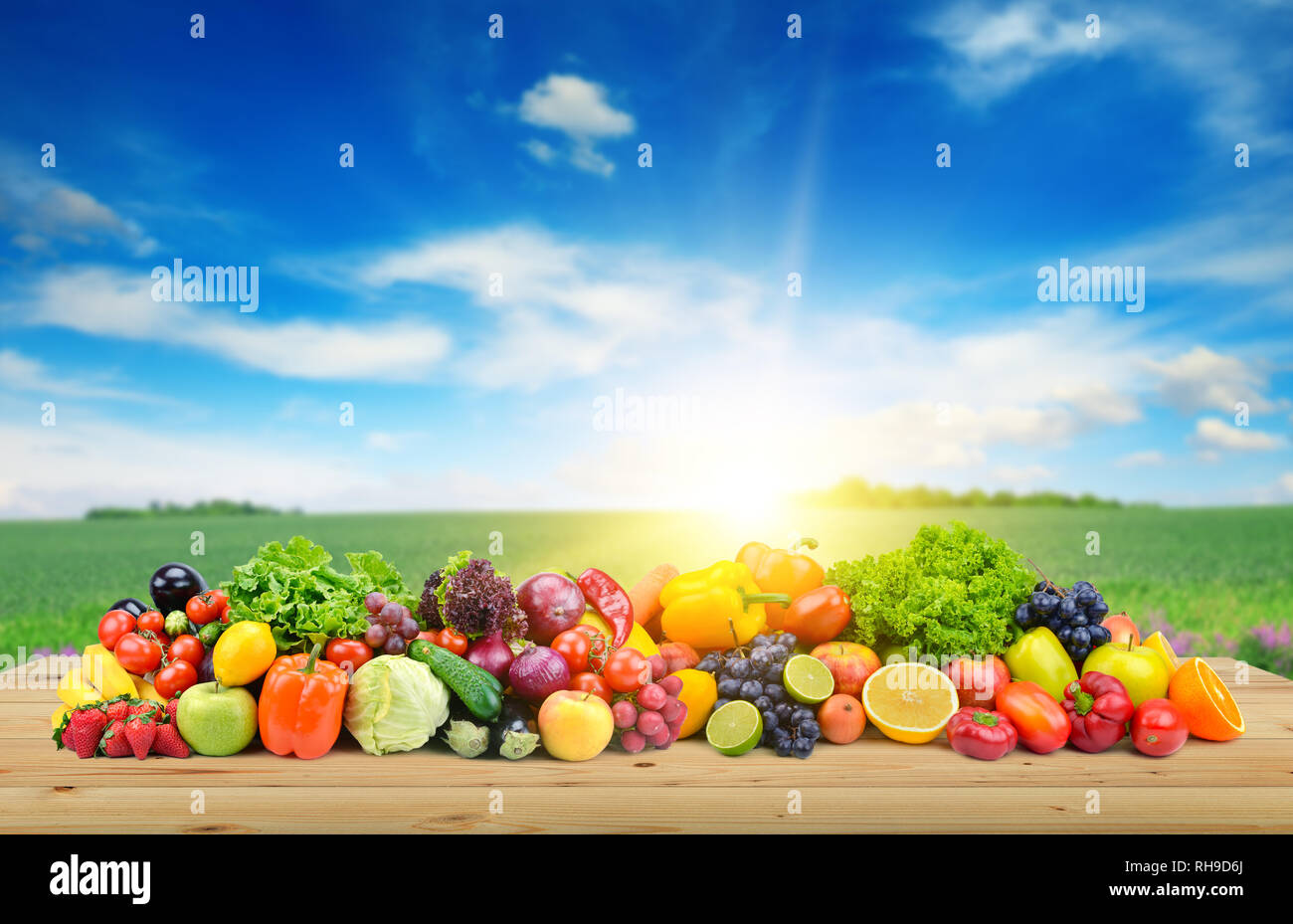 Vegetables and fruit on wooden table of boards against background of ...