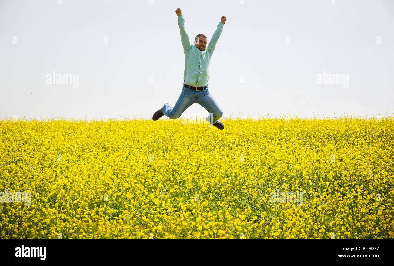 Jumping Happy Young Man Stock Photo - Alamy