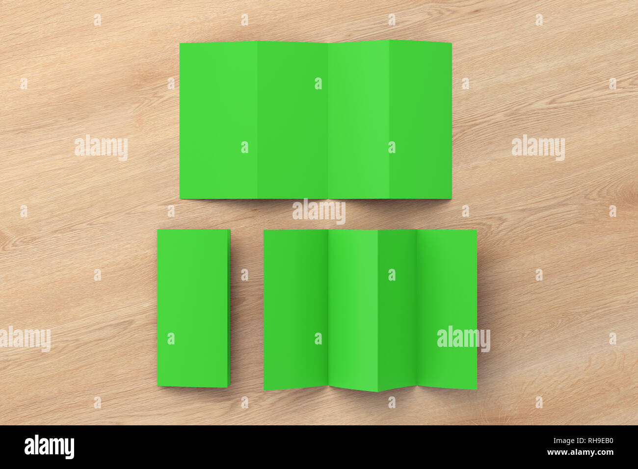 Blank green folded paper leaflet on wooden background. Eight pages ...