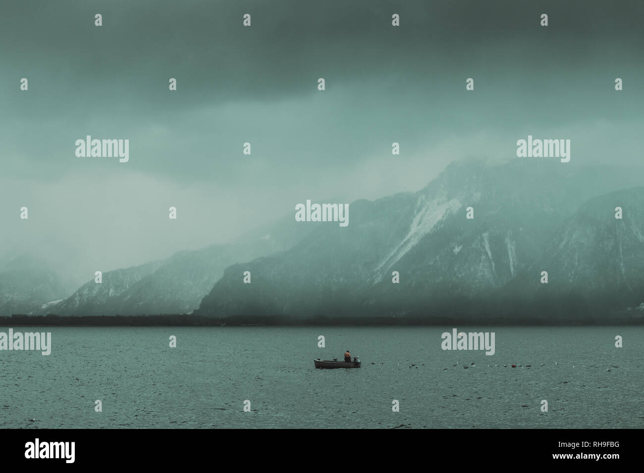 fisherman with boat alone on the lake Stock Photo - Alamy