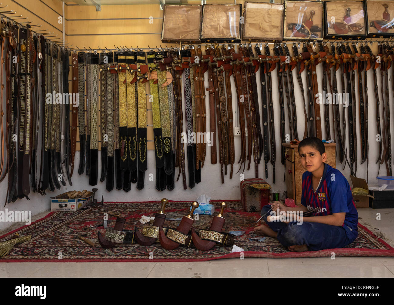 Saudi boy selling belts and janbiya daggers, Najran Province, Najran ...