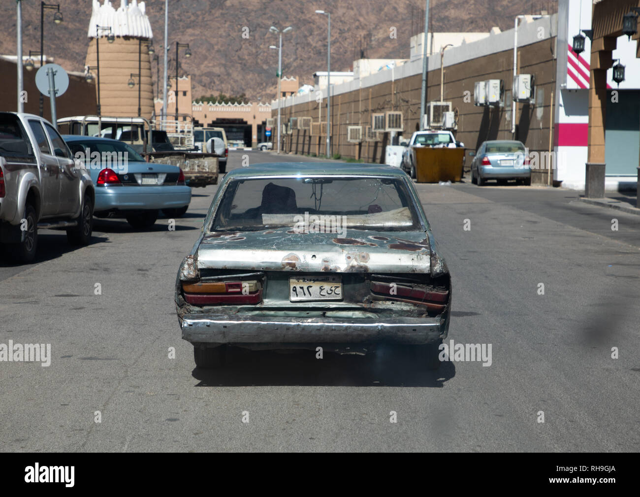 Rear view of a damaged car on a road, Najran Province, Najran, Saudi ...