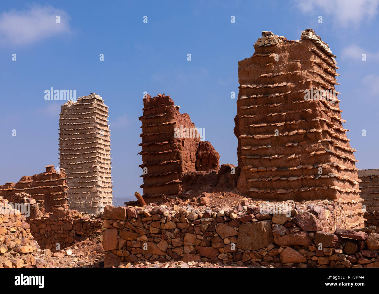 Red stone and mud houses and watchtower with slates in a village, Asir ...