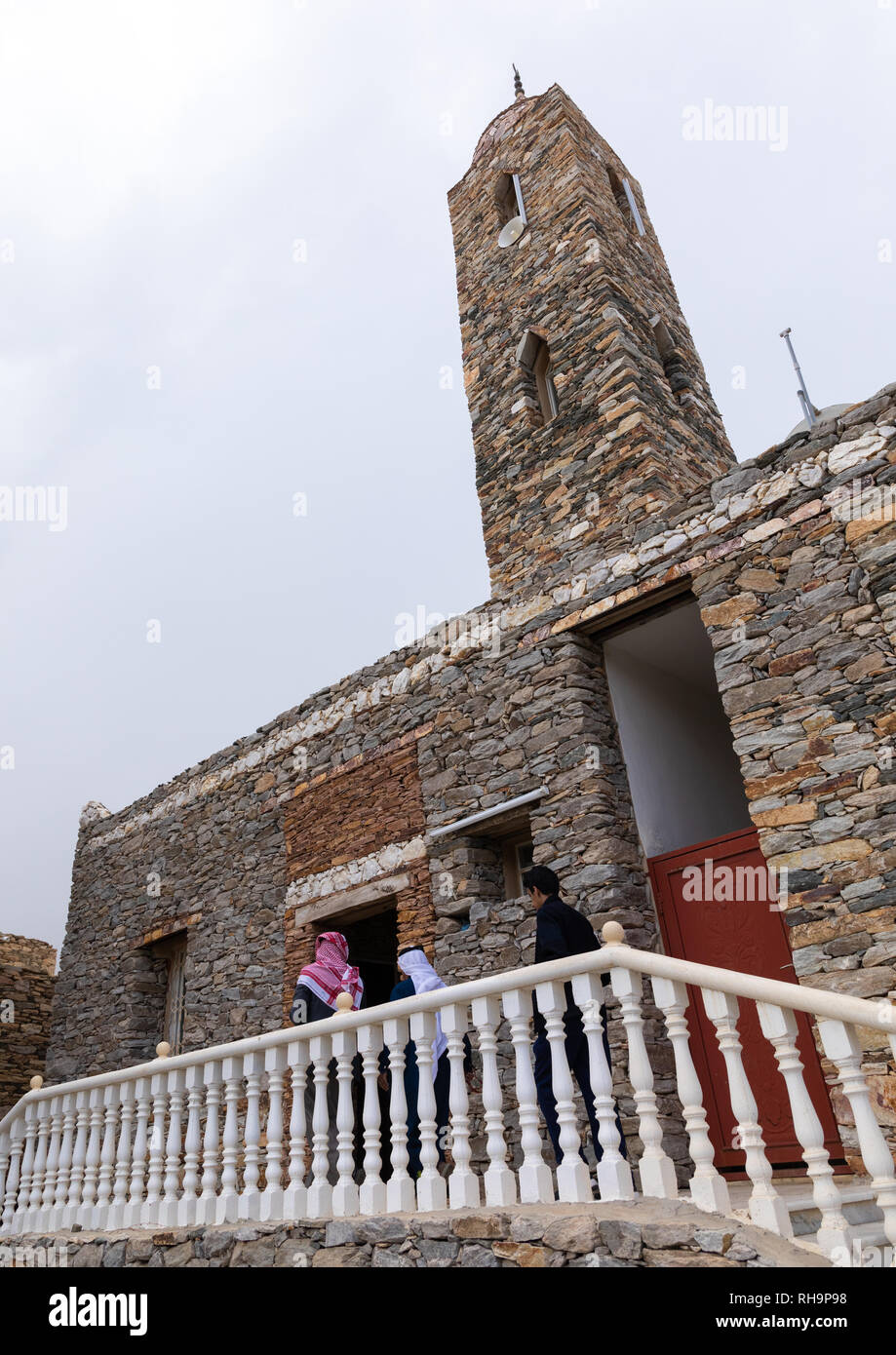 Saudi men entering a mosque made of stones, Asir province, Tanomah ...