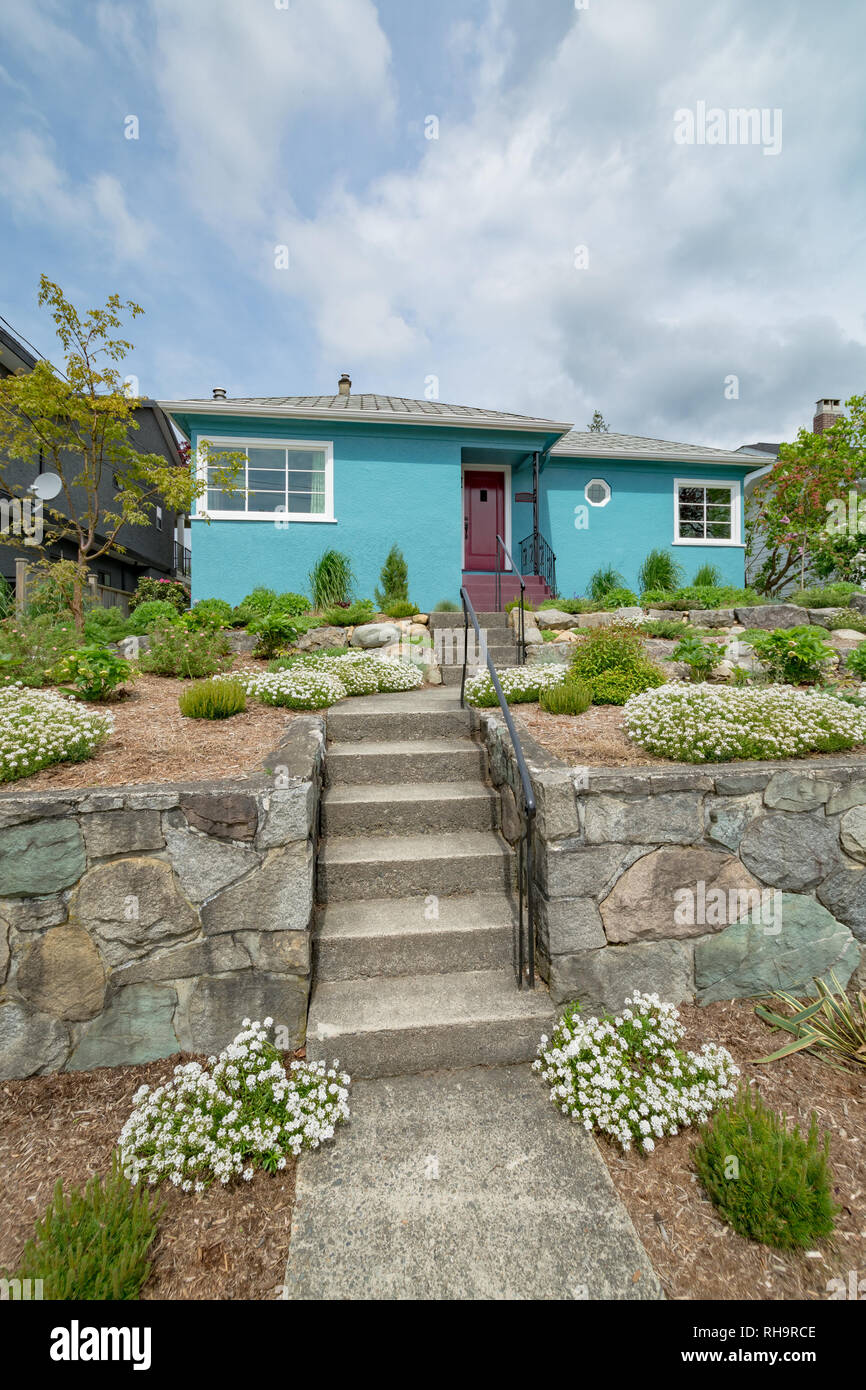 Concrete stairway to average residential house built on land terrace ...