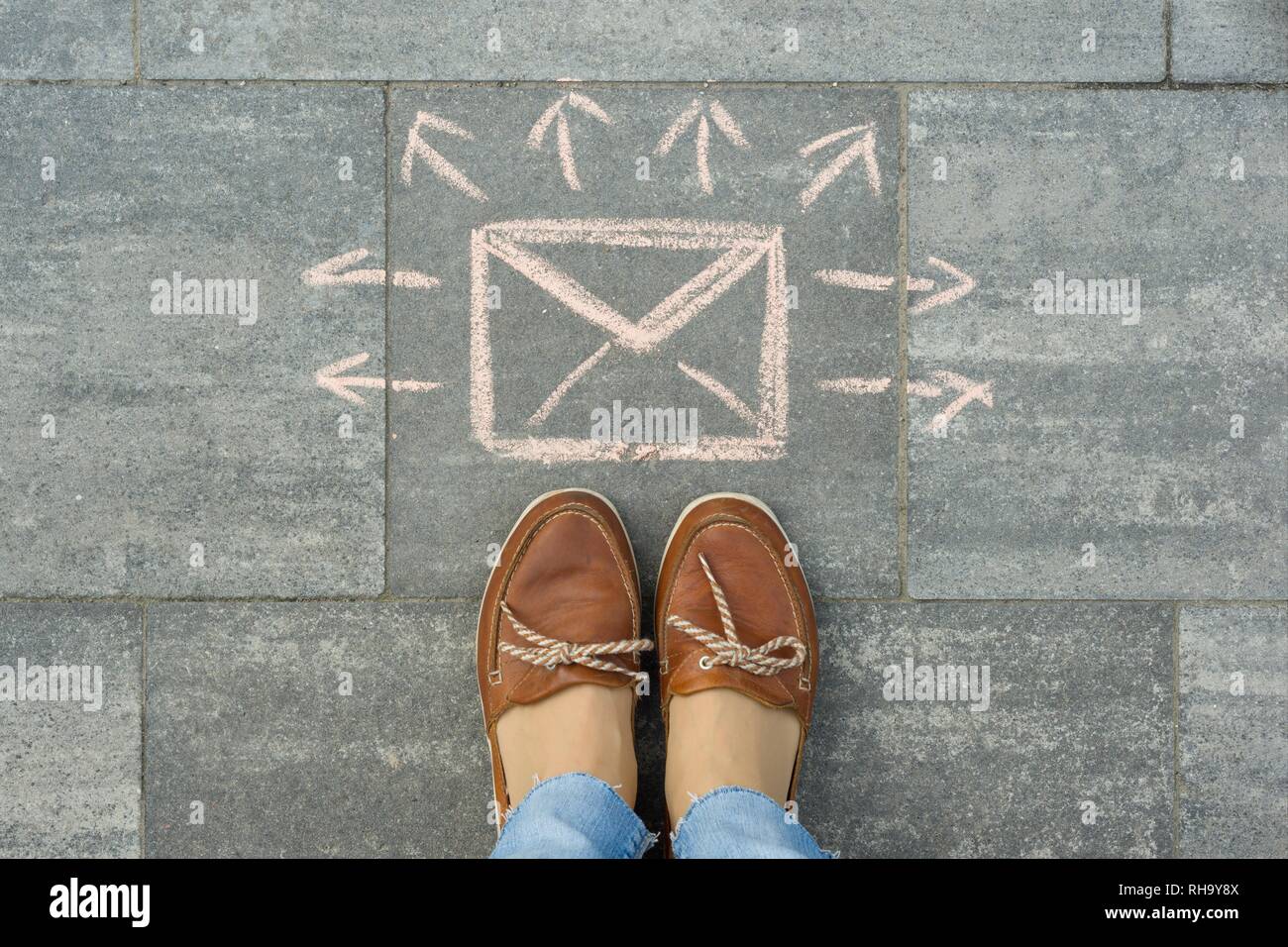 Female feet with abstract envelope message letter with arrows in ...