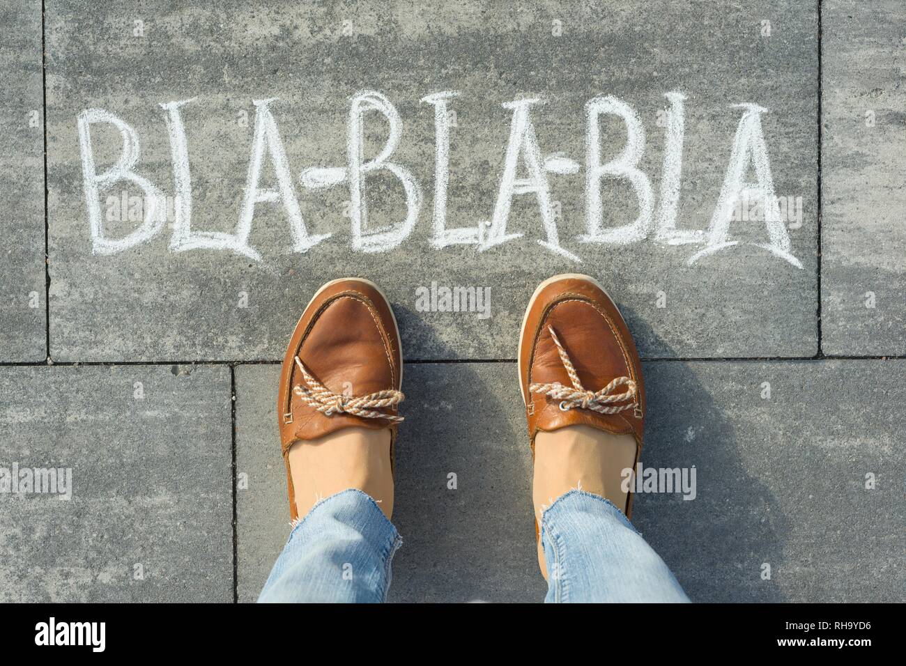 Female feet with text bla-bla-bla written on grey sidewalk Stock Photo ...