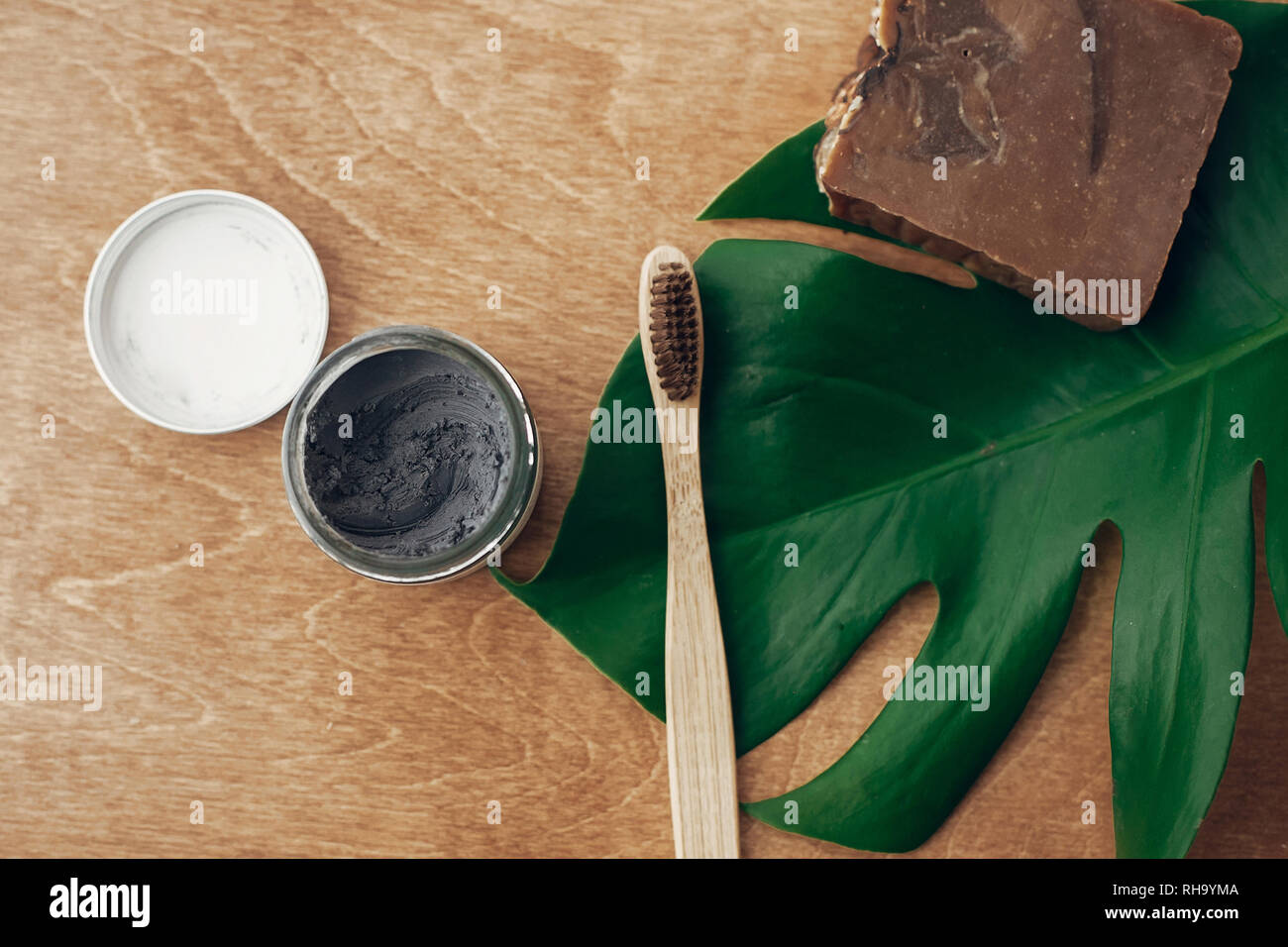 Natural toothpaste activated charcoal and bamboo toothbrush on wooden ...