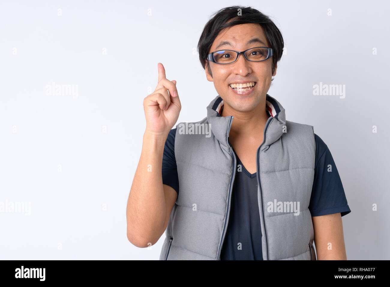 Portrait of happy Japanese man pointing up ready for hiking Stock Photo ...