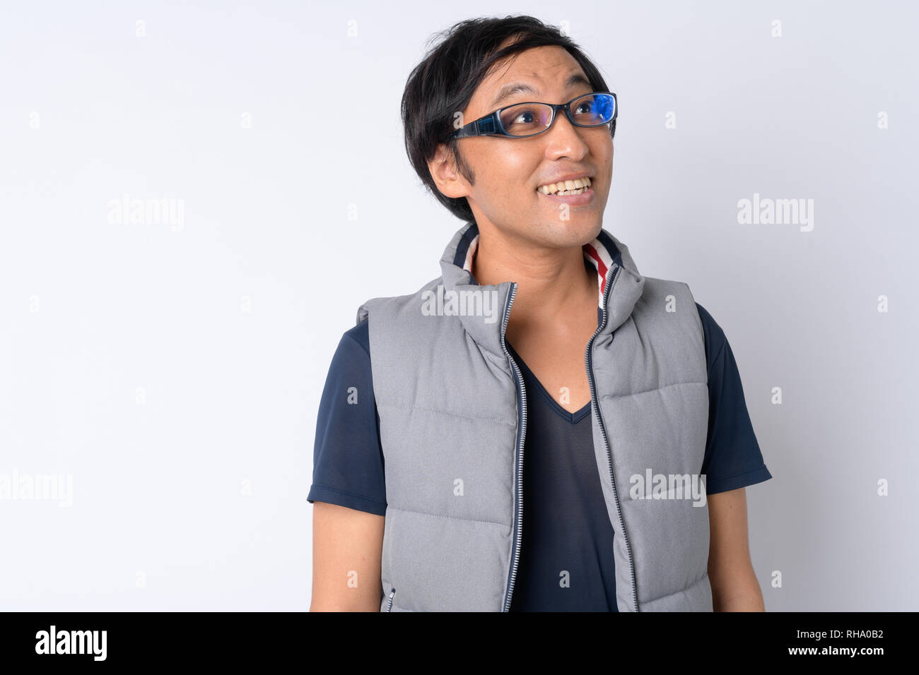 Portrait of happy Japanese man thinking and ready for hiking Stock ...