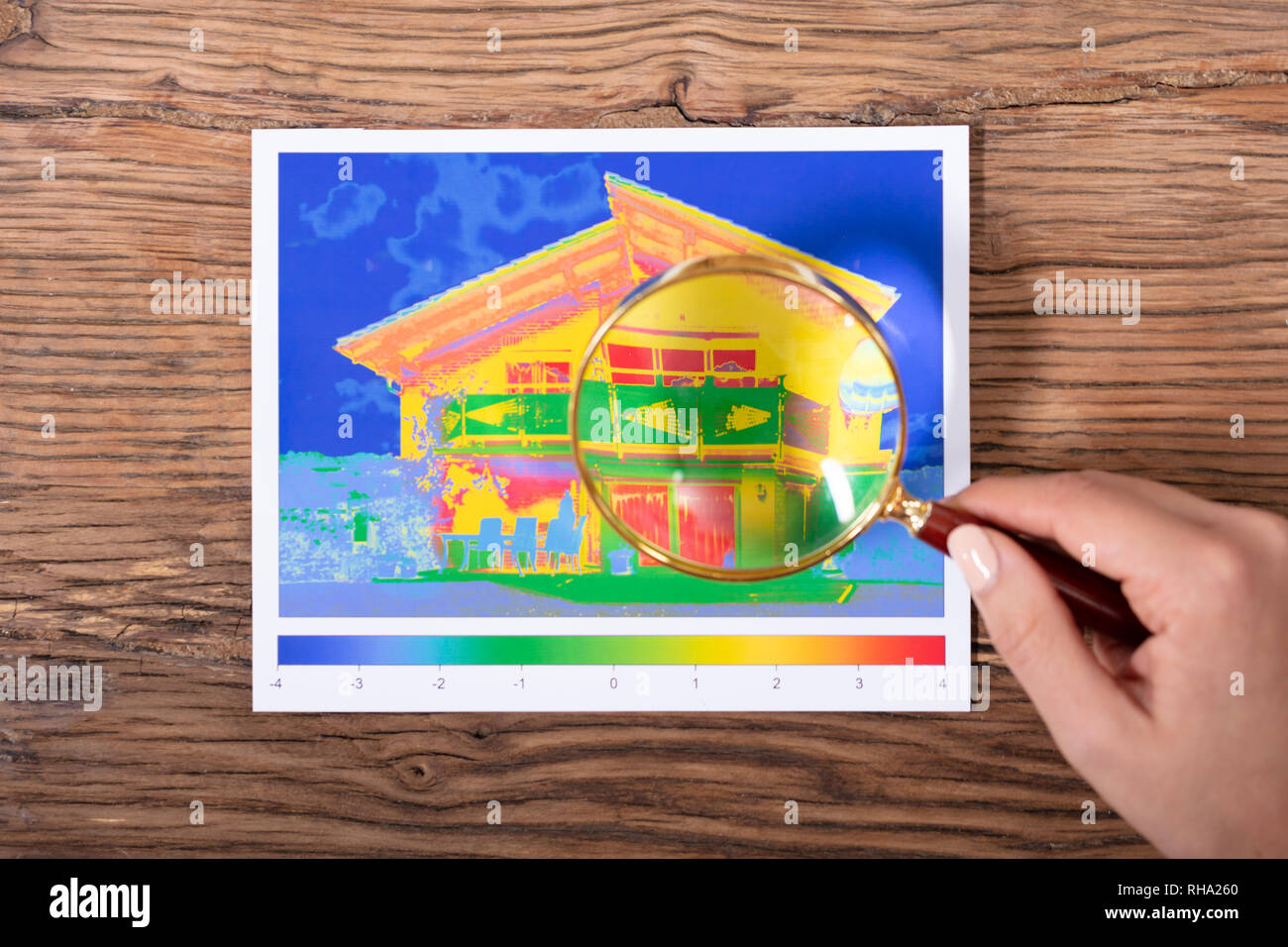 A Person Analyzing The Heat Loss And Energy Efficiency Of A House With ...