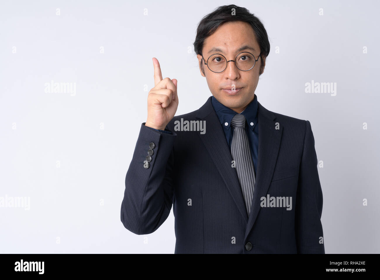 Portrait of Japanese businessman in suit pointing up Stock Photo - Alamy