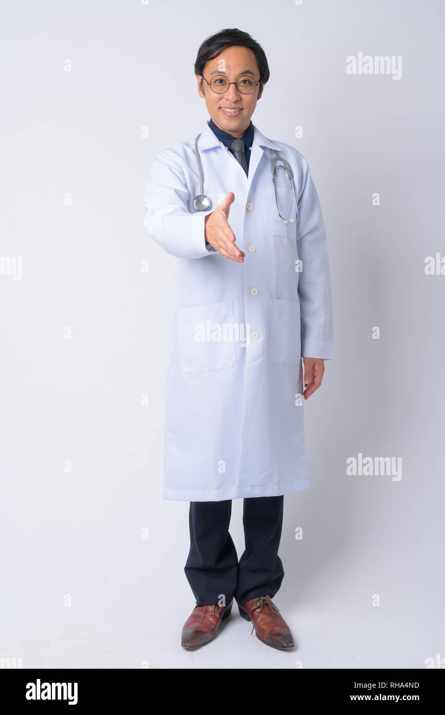 Full body shot of happy Japanese man doctor giving handshake Stock ...
