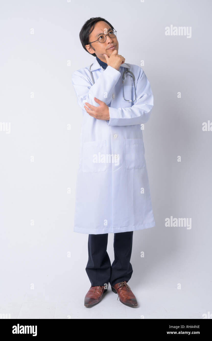 Full body shot of Japanese man doctor thinking Stock Photo - Alamy